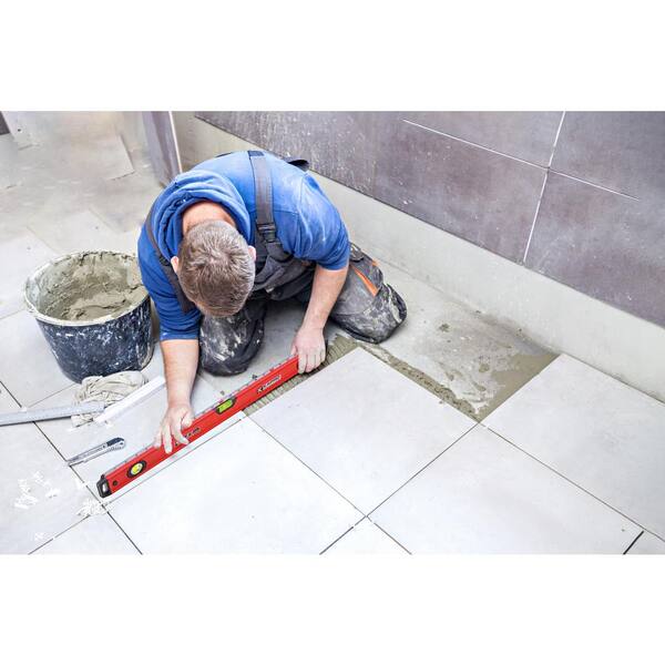 Ruler Installing Tile Floor Treatment