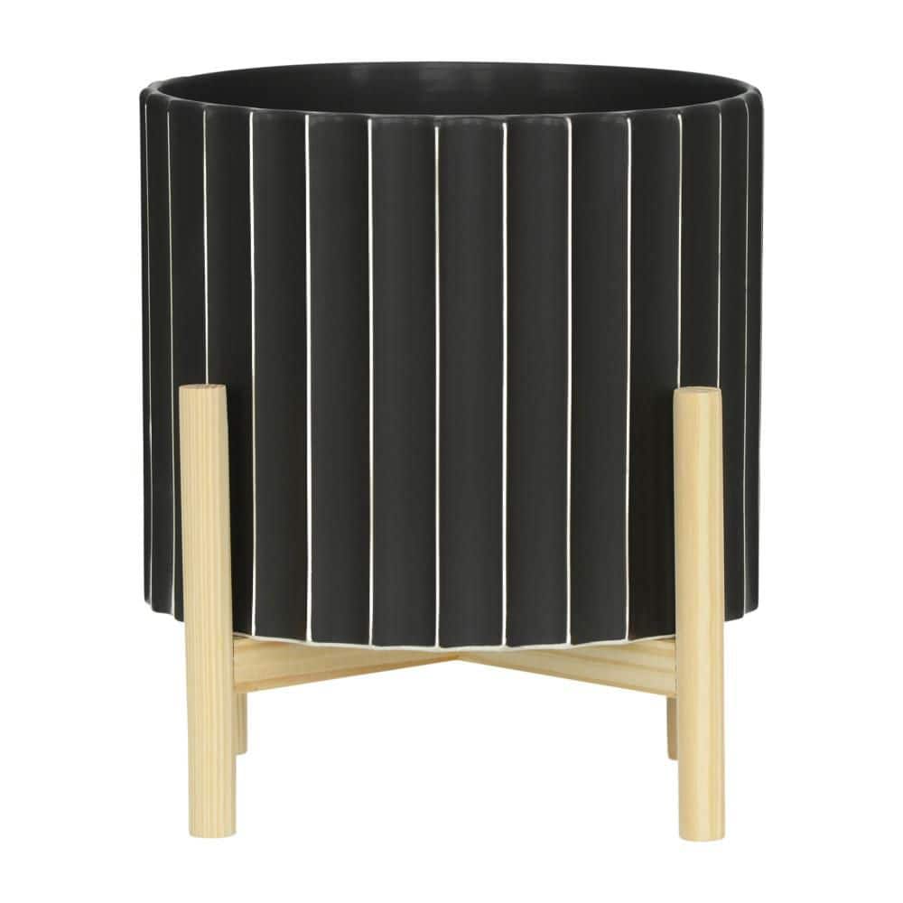 Liv & Skye Black Ceramic Fluted Planter (10 in. W x 11 in. H) with Wood ...